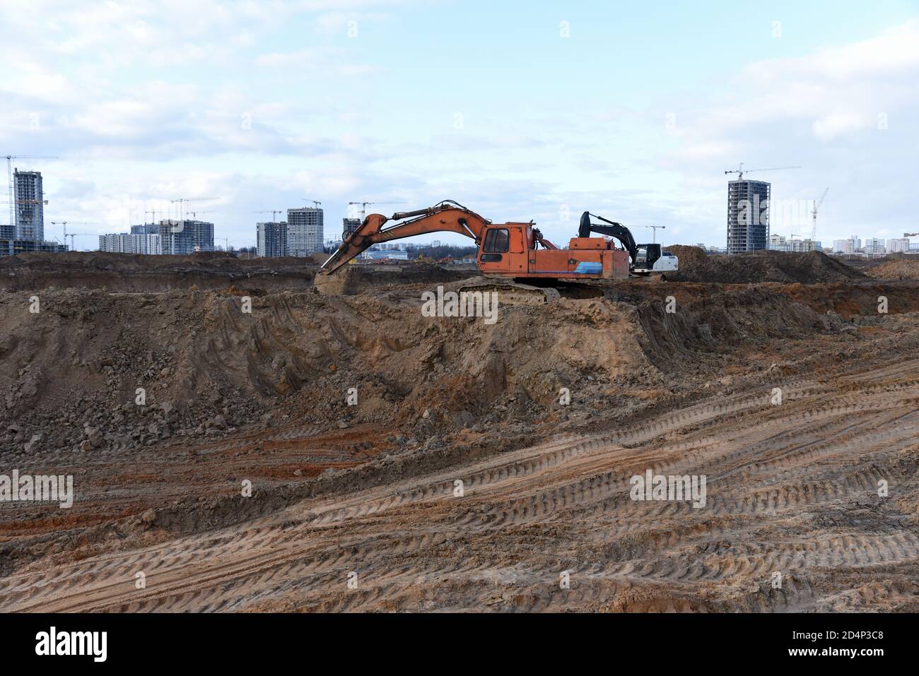 Group of the excavators for dig ground trenching at a construction site ...