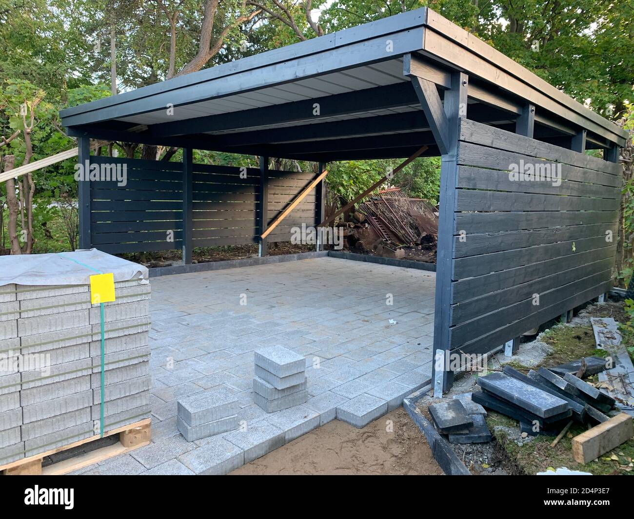 Paving stones, which stand on pallets, are laid in the carport Stock ...