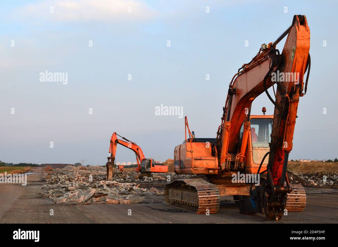 Excavator with hydraulic breaker hammer at construction site ...