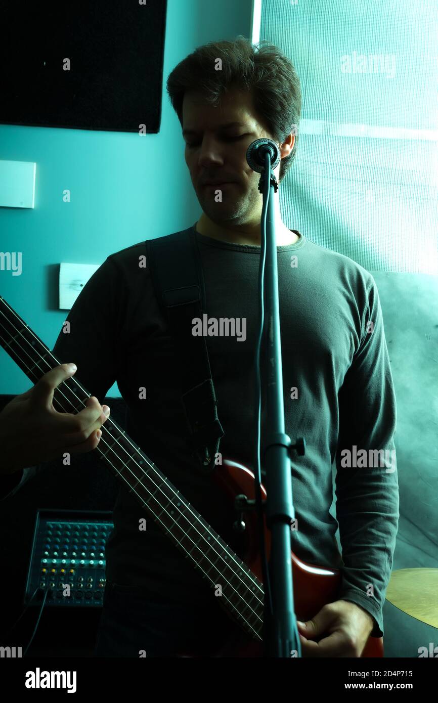 Black and white Portrait of a Rock singer playing bass in the rehearsal ...
