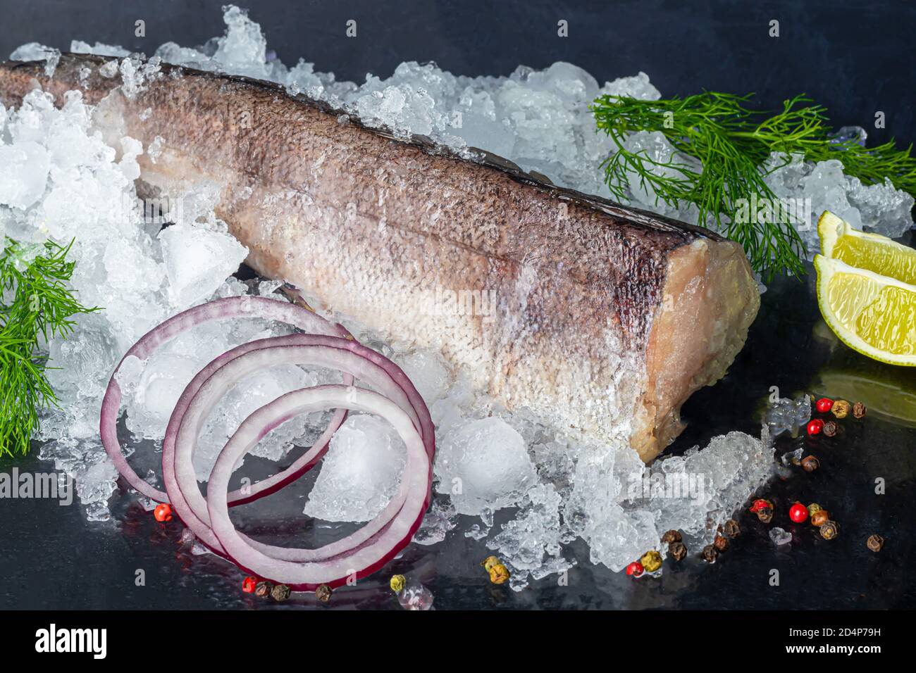 Fresh frozen hake carcass. Fish fillet with culinary ingredients, herbs ...