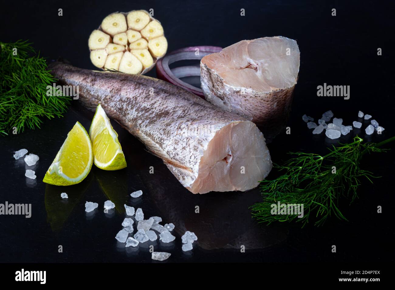 Fresh frozen hake carcass. Fish fillet with culinary ingredients, herbs ...
