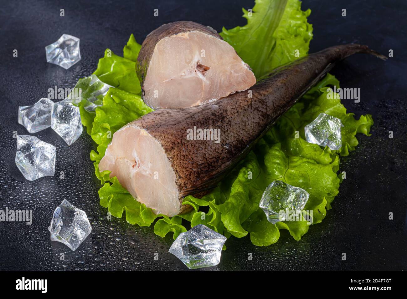Fresh frozen hake carcass. Fish fillet with culinary ingredients, herbs ...