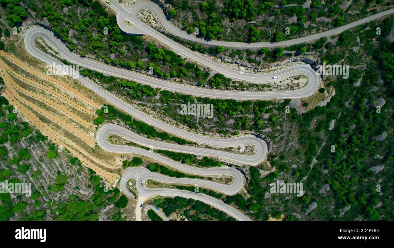 Aerial view of twisted road. Top view of mountain serpentine road with ...