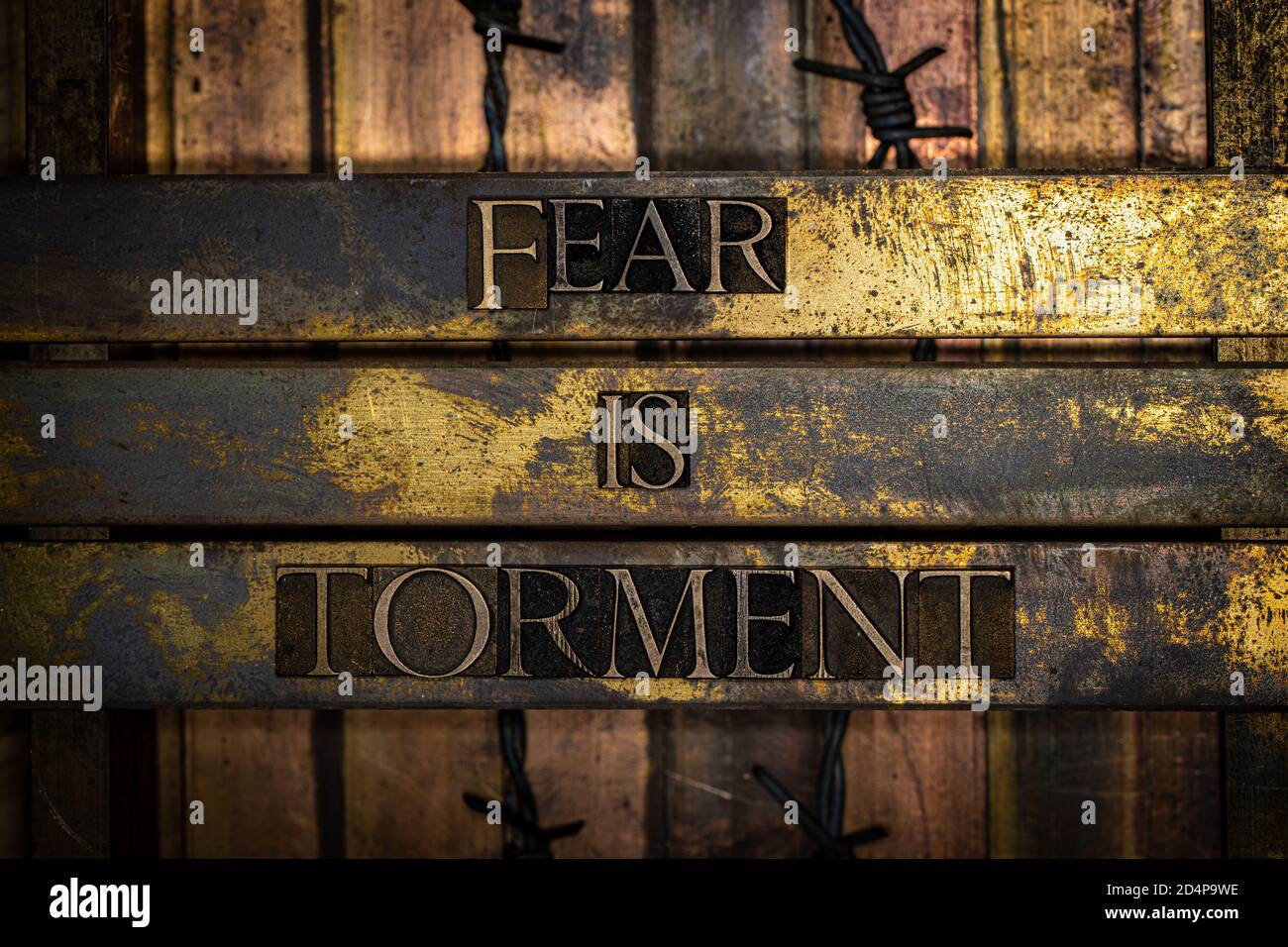 Fear is Torment text message on textured grunge copper and vintage gold ...