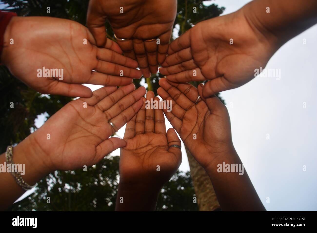 Close up of the raised palms of six Indian girls showing their fingers ...