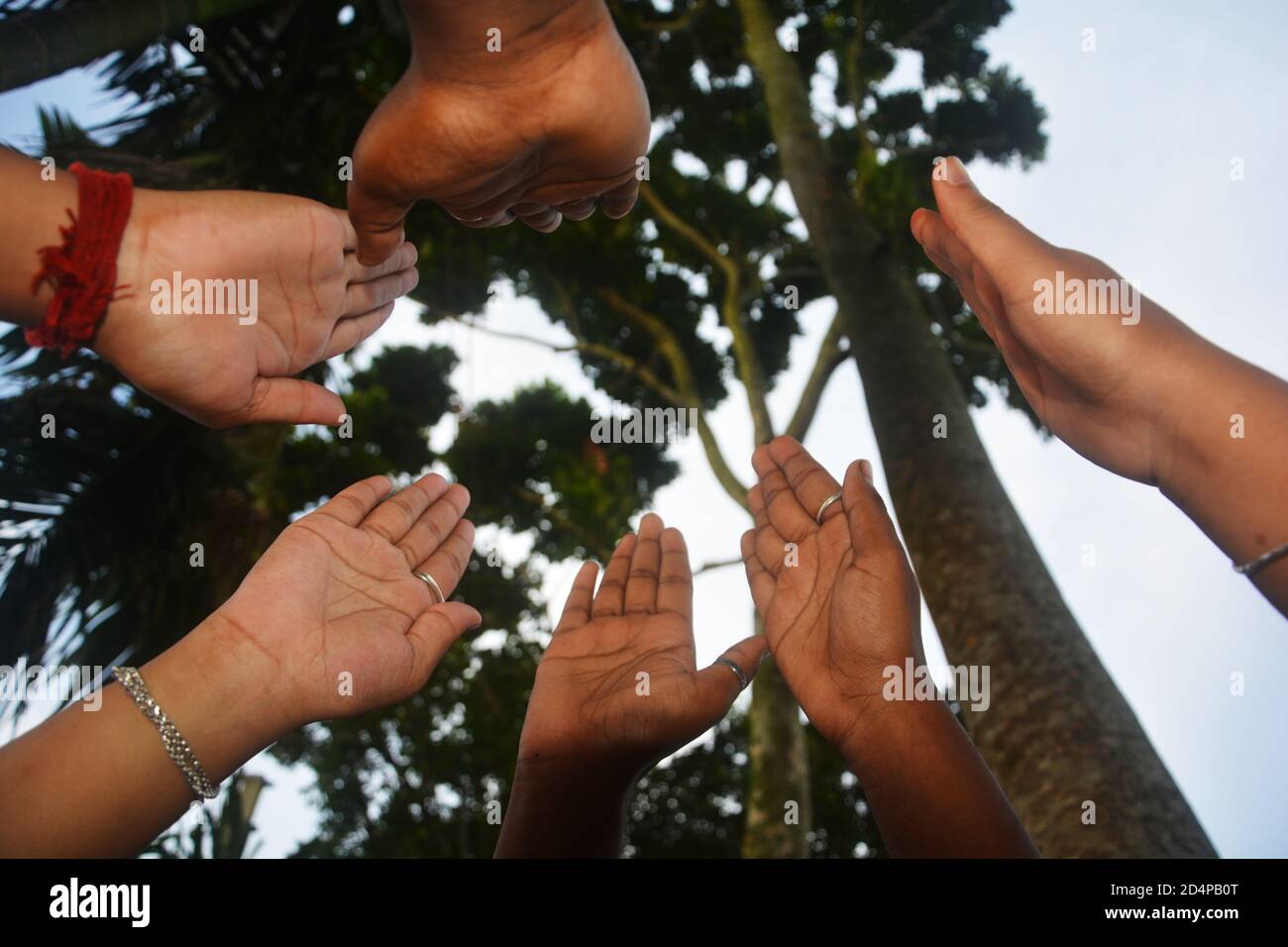 Close up of the raised palms of six Indian girls showing their fingers ...