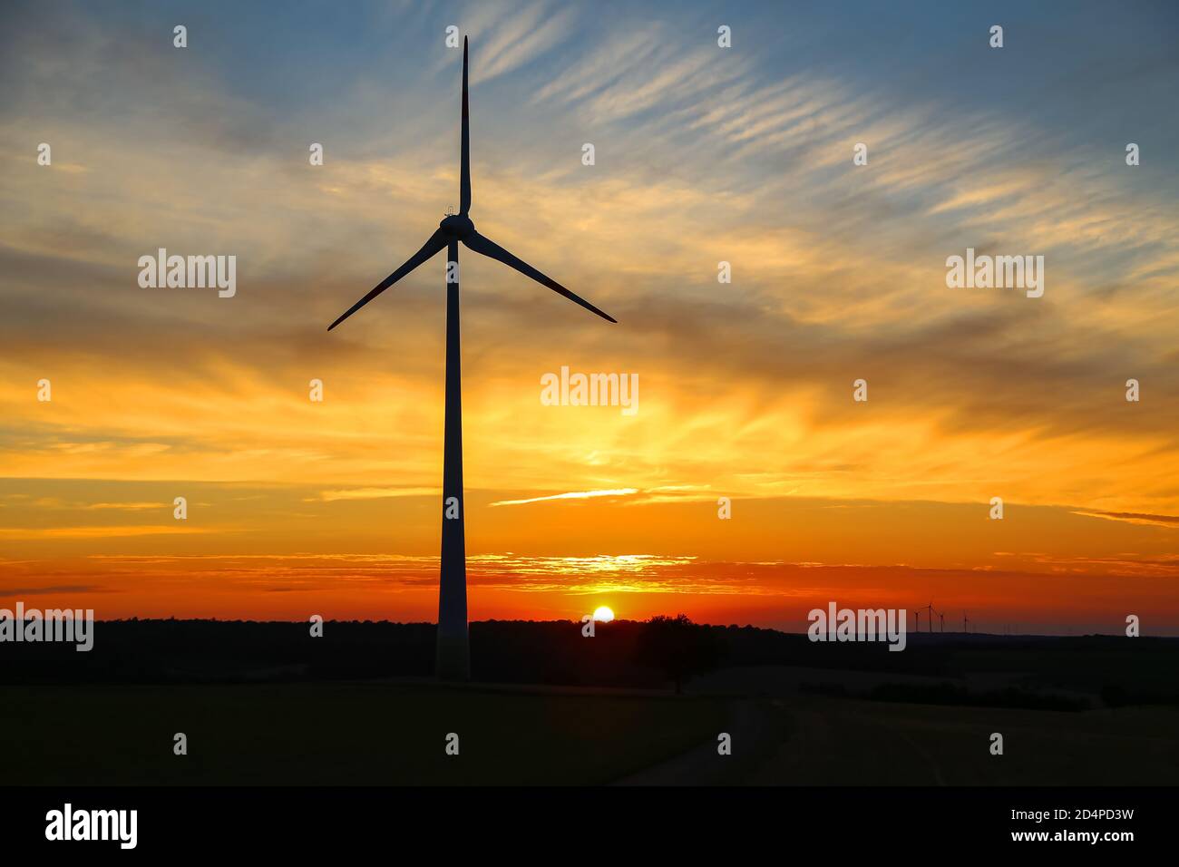 Sunny sunset with beautiful clouds and a silhouette of a windmill Stock ...