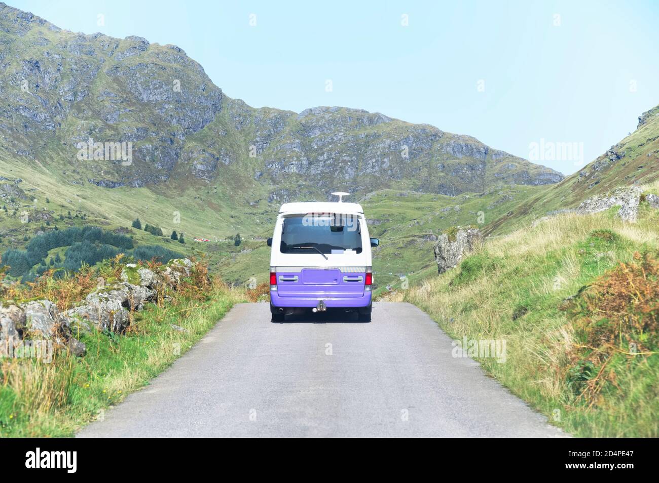 Purple campervan in remote mountain road trip Stock Photo - Alamy