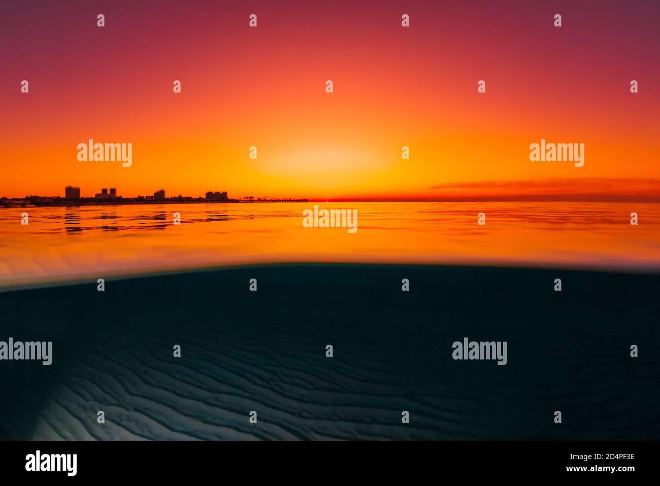 Split view with bright sunset and underwater sandy sea bottom Stock ...