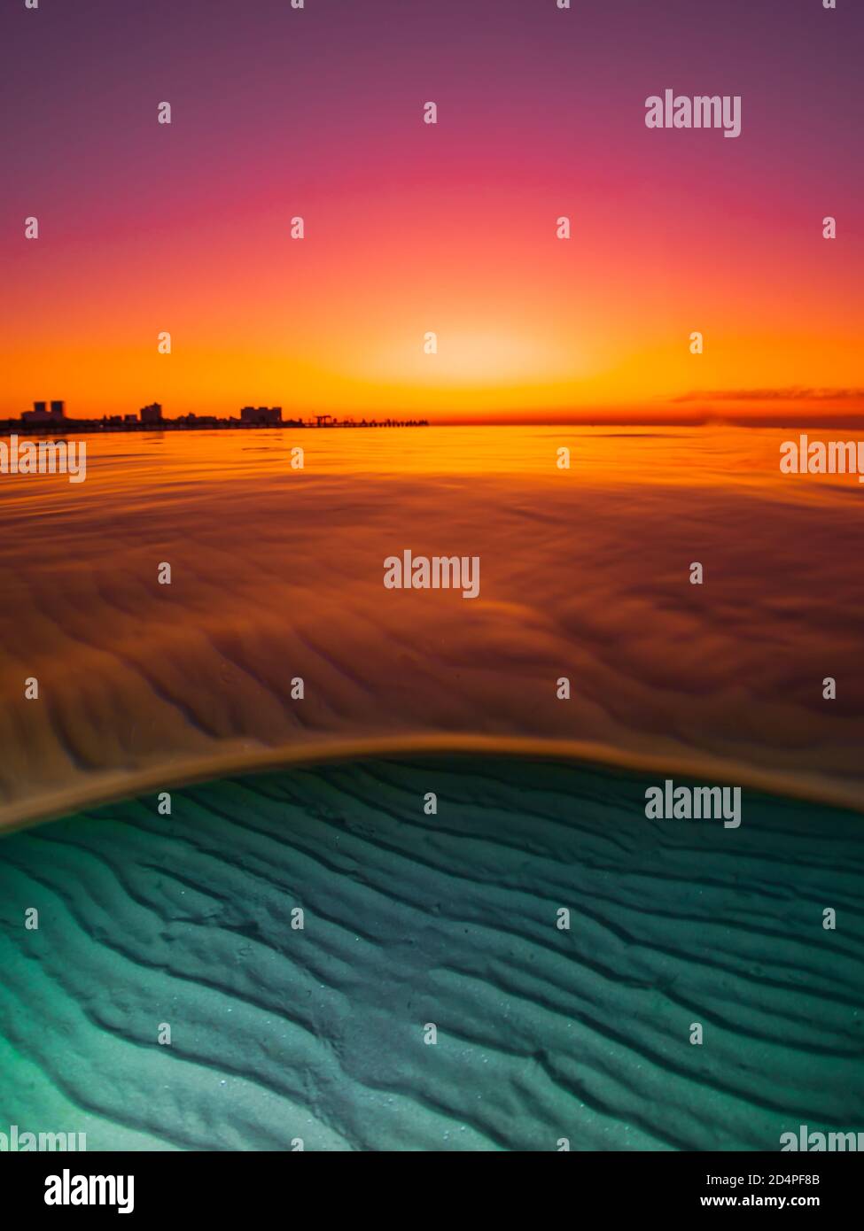 Split view with bright sunset and underwater sandy sea bottom Stock ...
