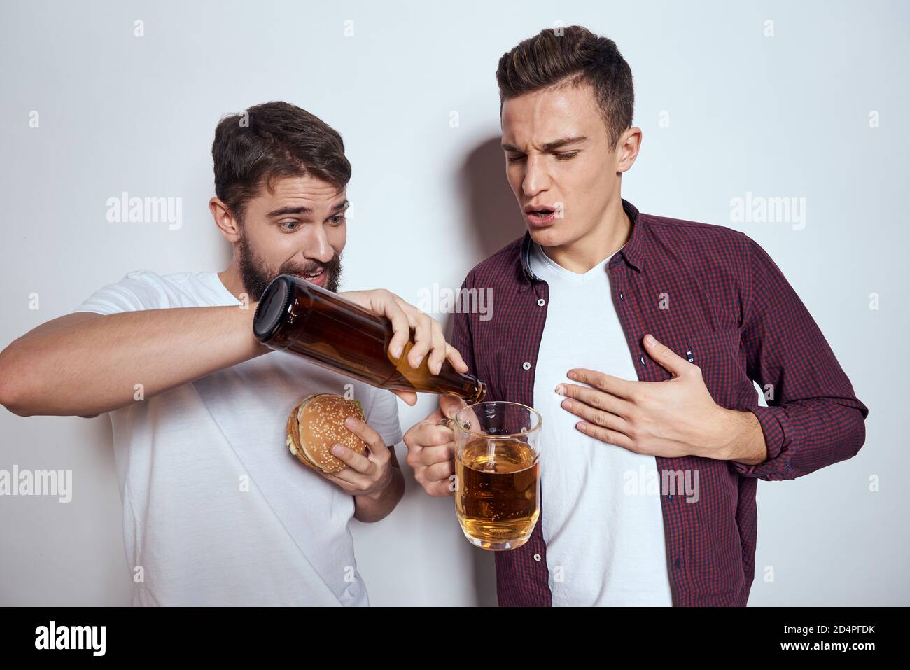 Two friends drink beer leisure fun alcohol friendship lifestyle light ...