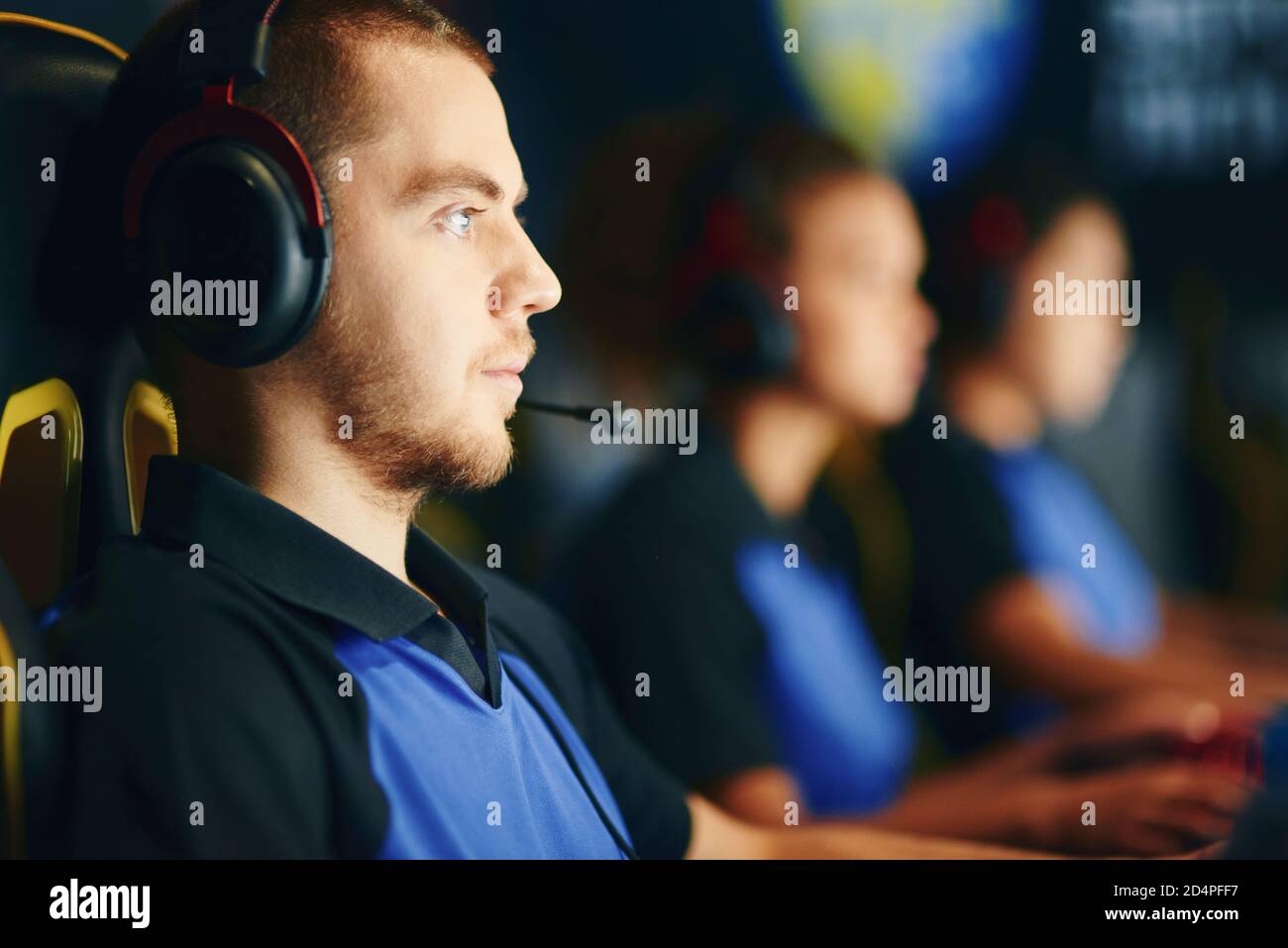 Side view of a focused caucasian guy, male cybersport gamer wearing ...