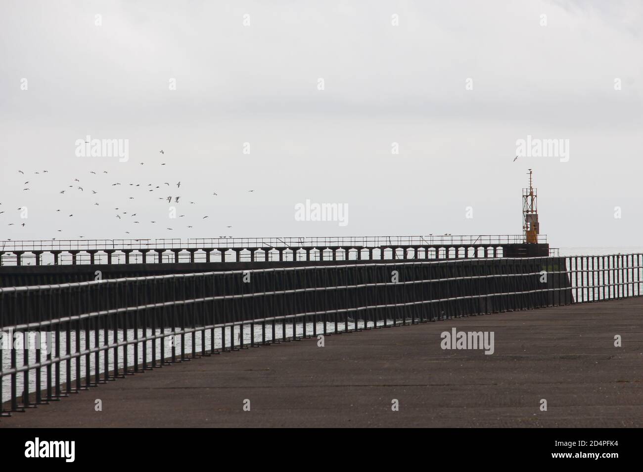 A photograph of a long pier out to sea at Aberafan beach, south Wales ...
