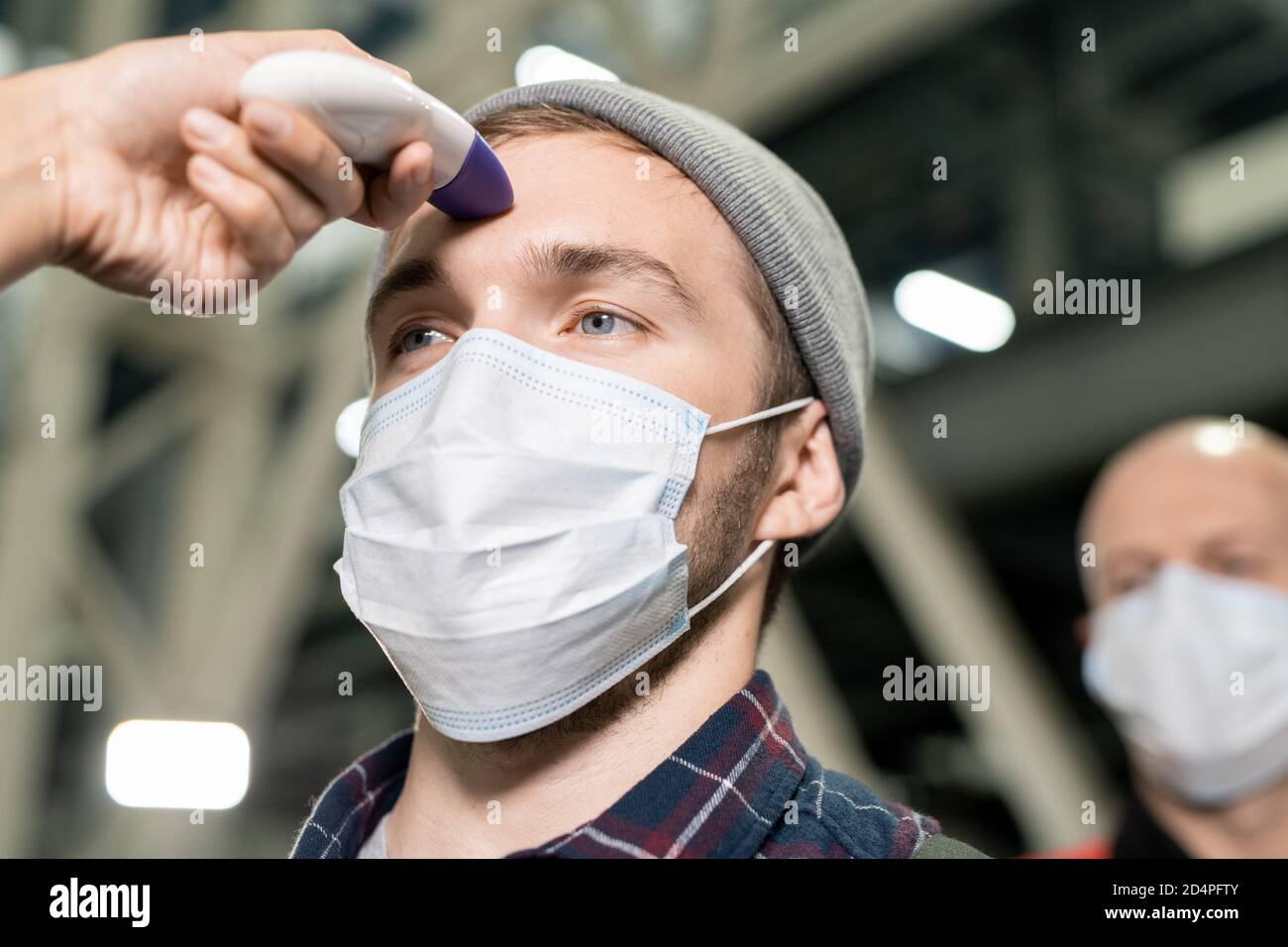 Hand of medical worker measuring body temperature with contactless ...