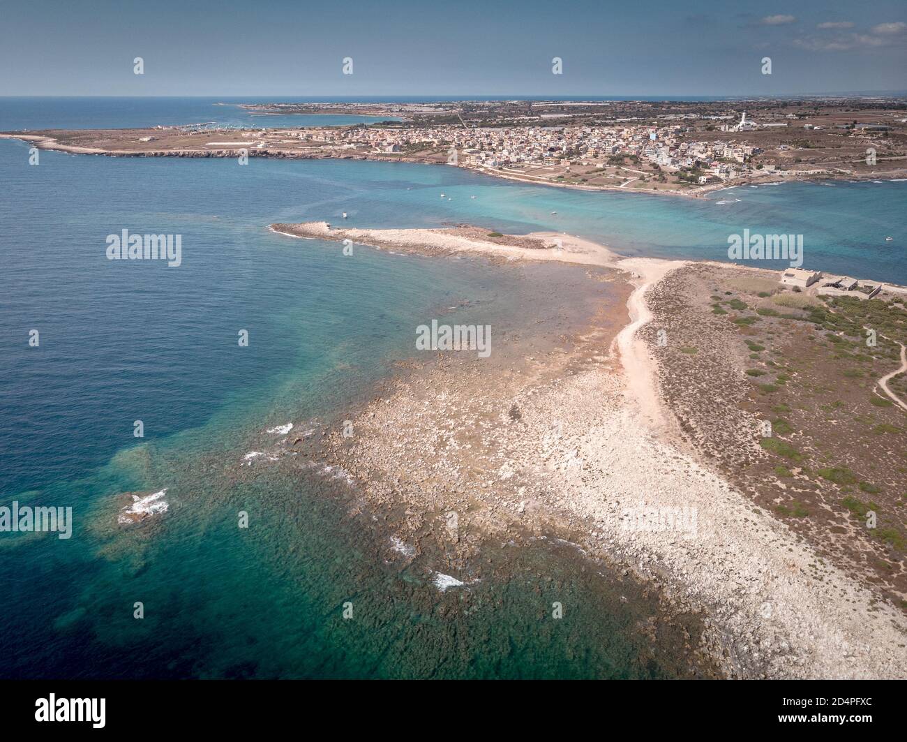 Aerial shot of the coastline of Capo Passero island and Portopalo town ...