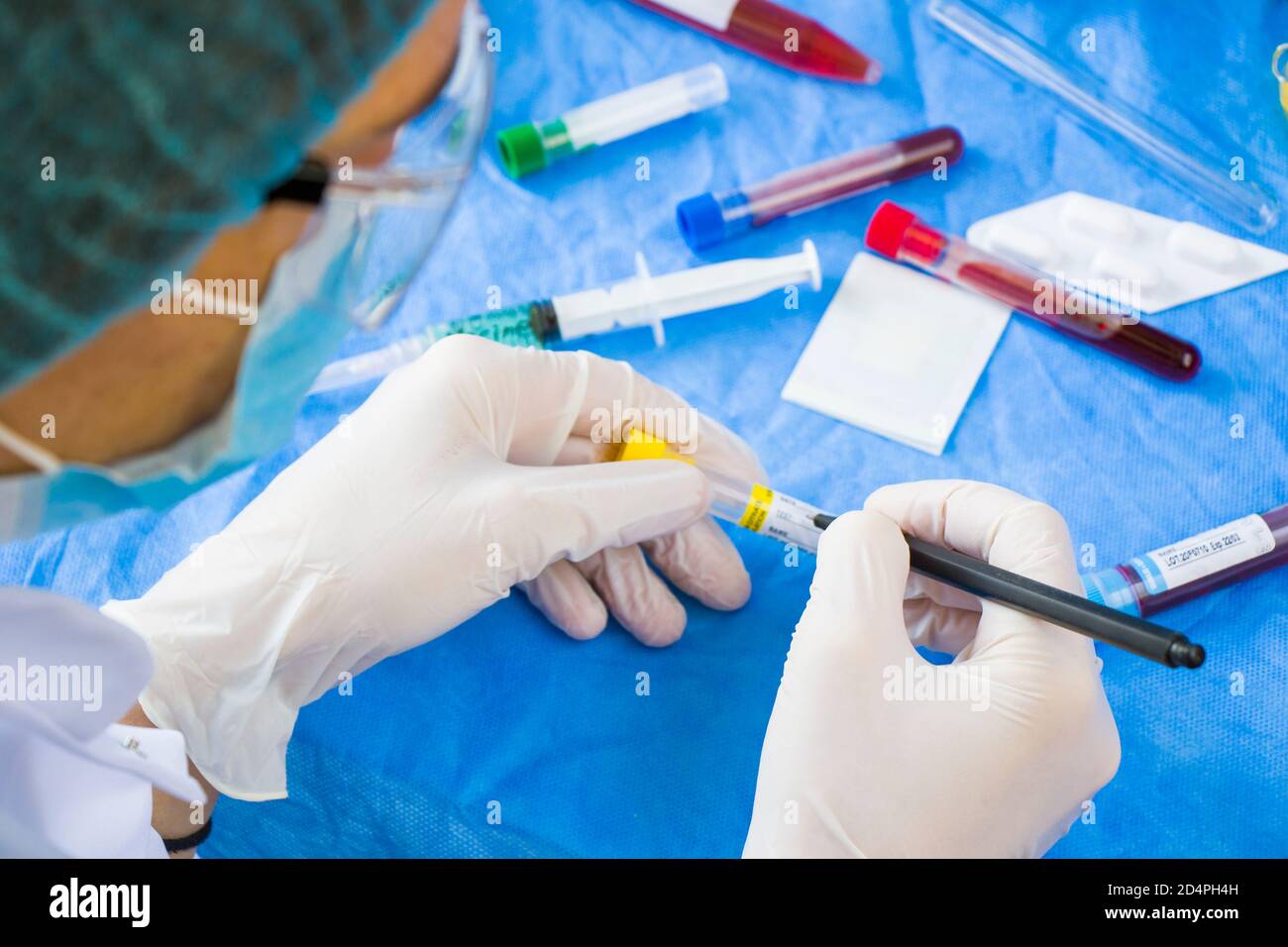 Doctor in laboratory with uniform write text on the blood tube sample ...