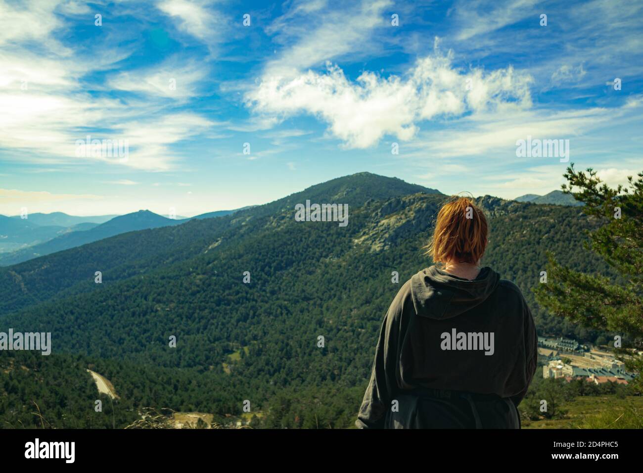 Back view of a person looking out over scenic hills Stock Photo - Alamy