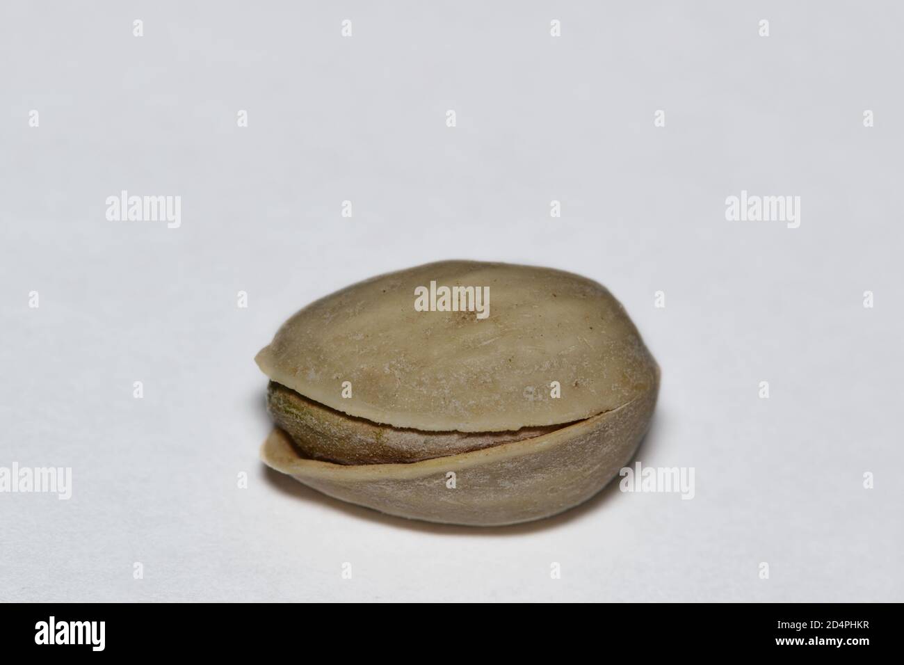 Single Pistachio nut isolated macro image on a plain white background ...