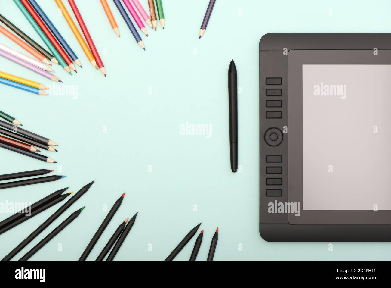 Graphic monitor stylus on lime color table. Black tablet computer with ...