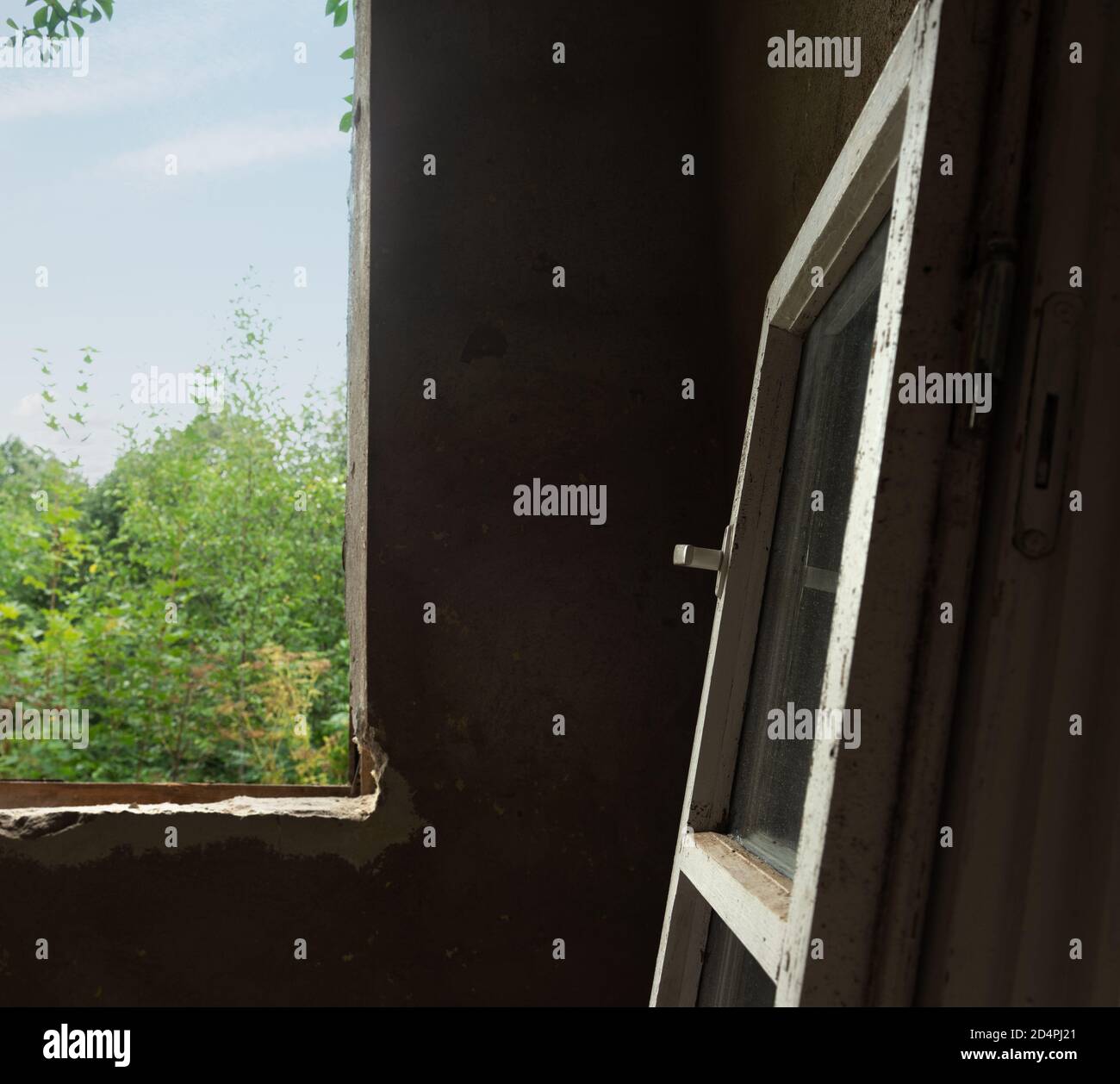 View to frame of old window and empty hole in house Stock Photo - Alamy