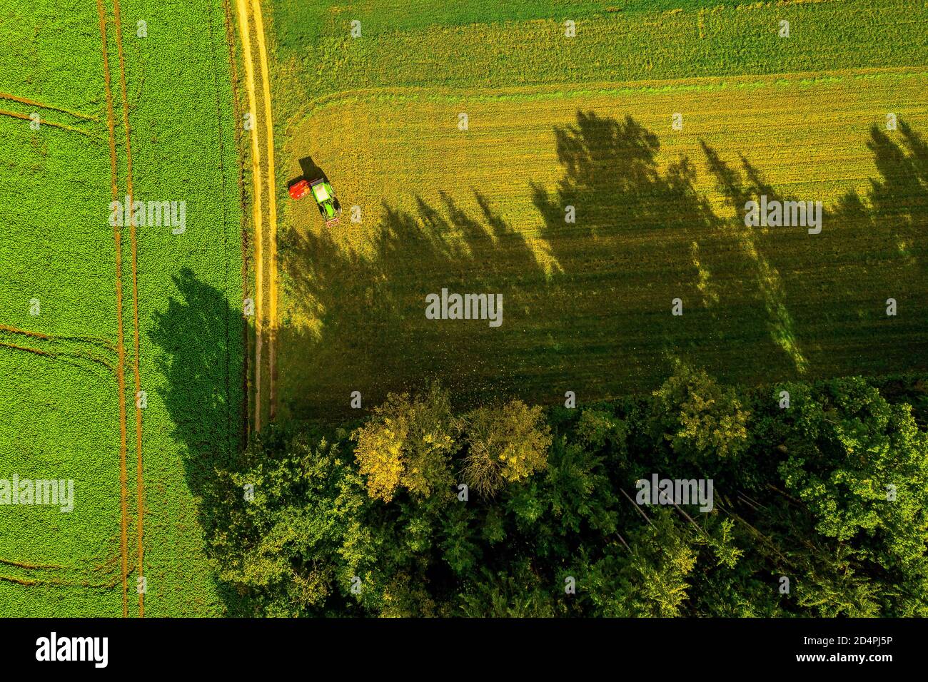 Aerial view of farm area with tractor standing in evening light Stock ...