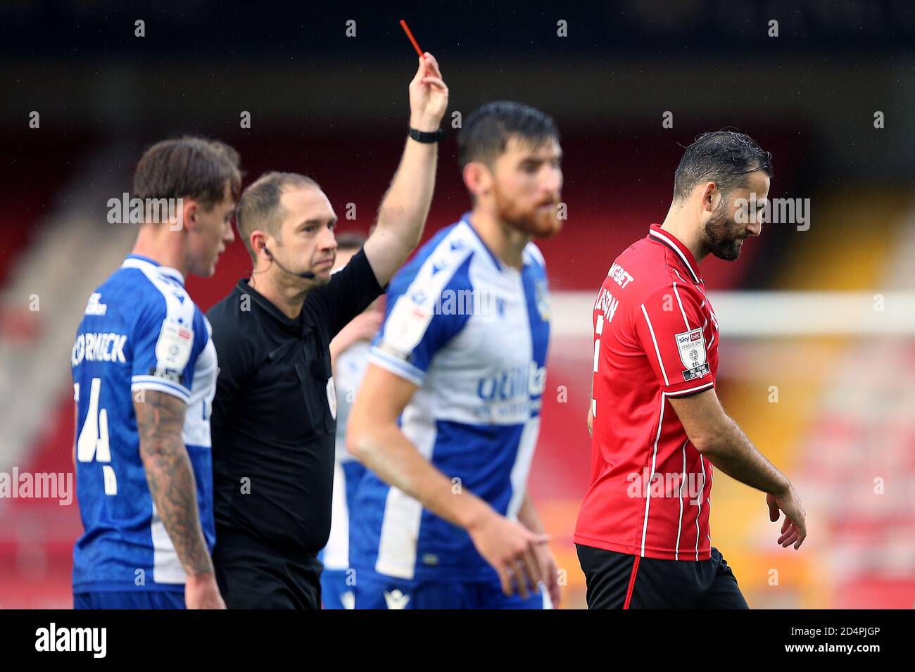 Lincoln City’s Adam Jackson reacts after being shown a red card by ...