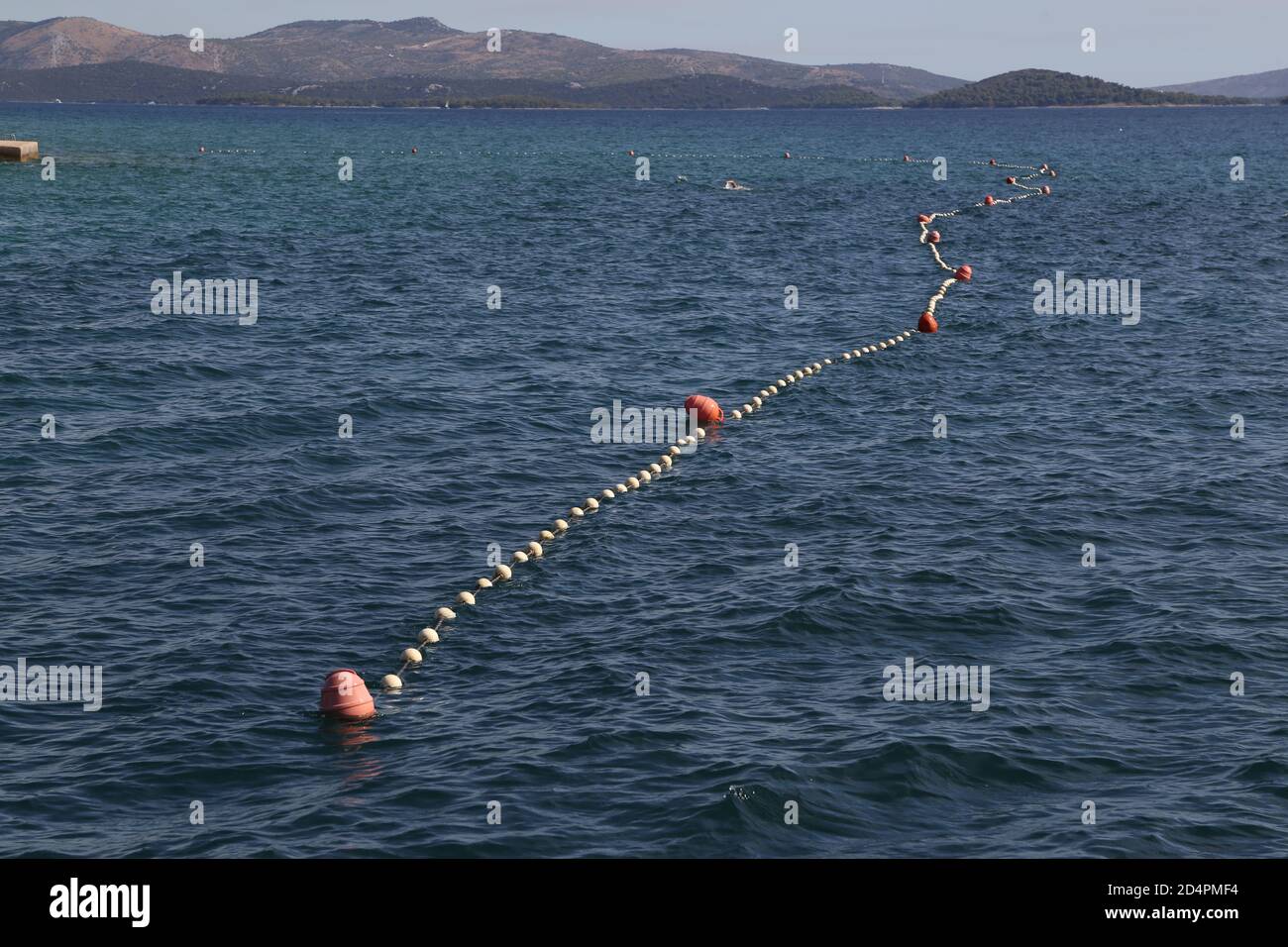 Rope with buoys for safe swimming area on the beach Stock Photo - Alamy