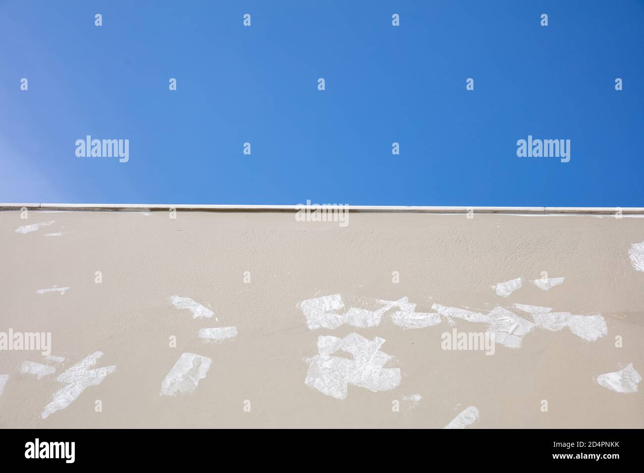 Building facade painting preparation. Beige color exterior wall ...