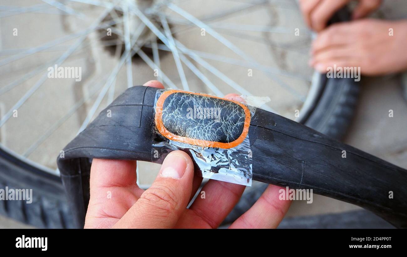 repairing a bicycle tire, repairing a flat tire Stock Photo - Alamy
