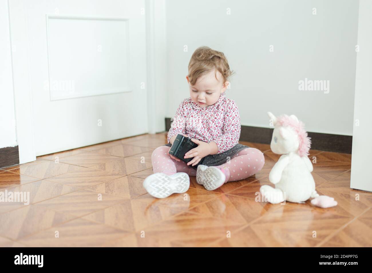 Baby girl playing at home Stock Photo - Alamy