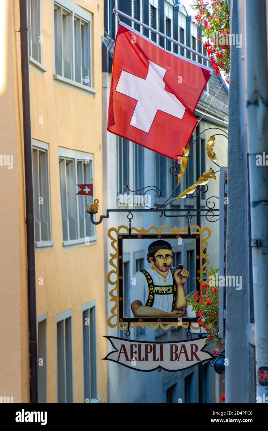 ZURICH, SWITZERLAND, JUL 30 2020, The swiss flag with hanging sign of ...