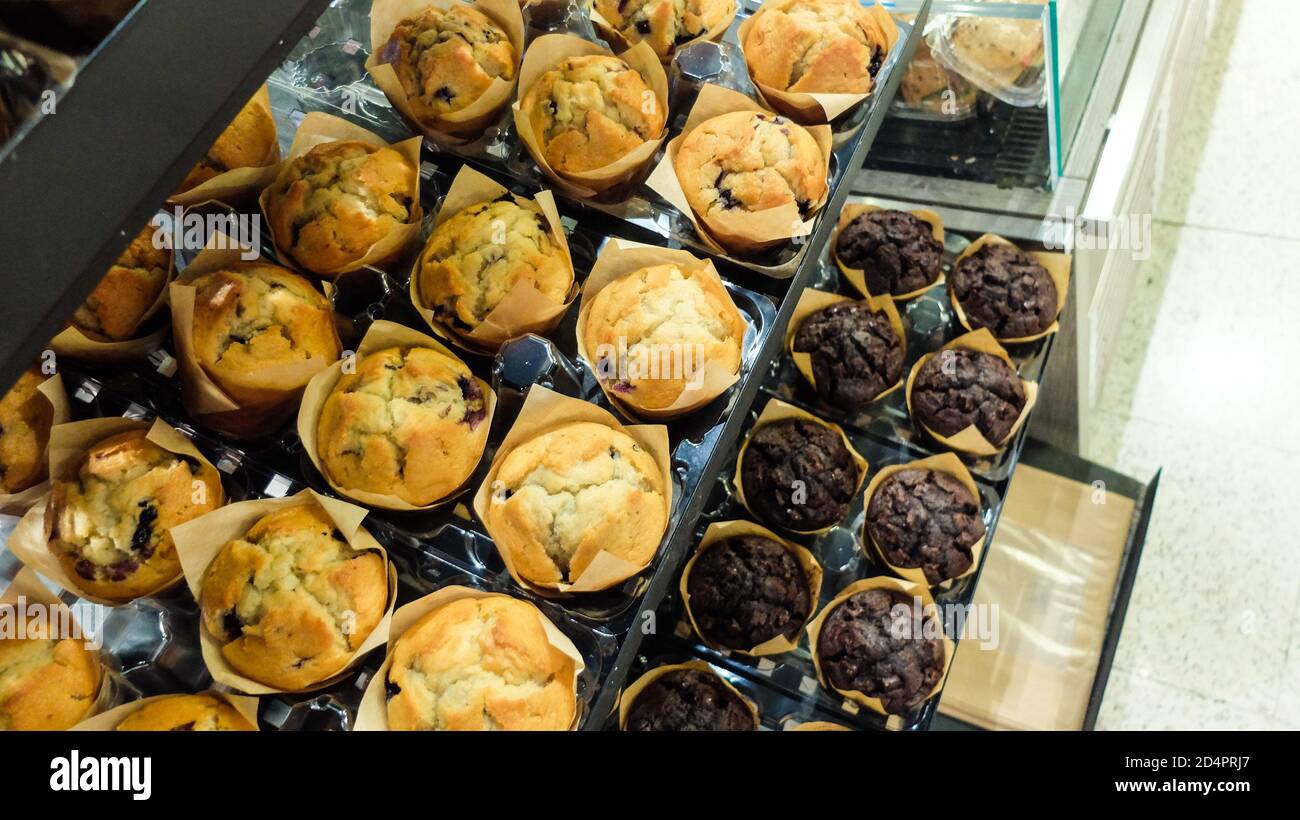 Fresh and tasty muffins on display at the supermarket Stock Photo - Alamy