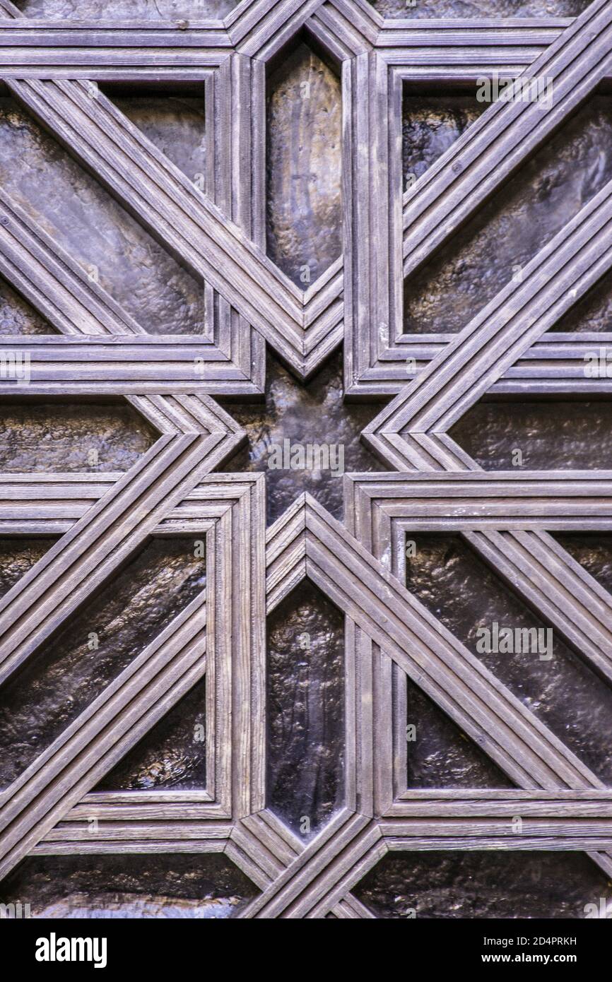 Vertical closeup of a lattice work on a wooden door with a star design ...