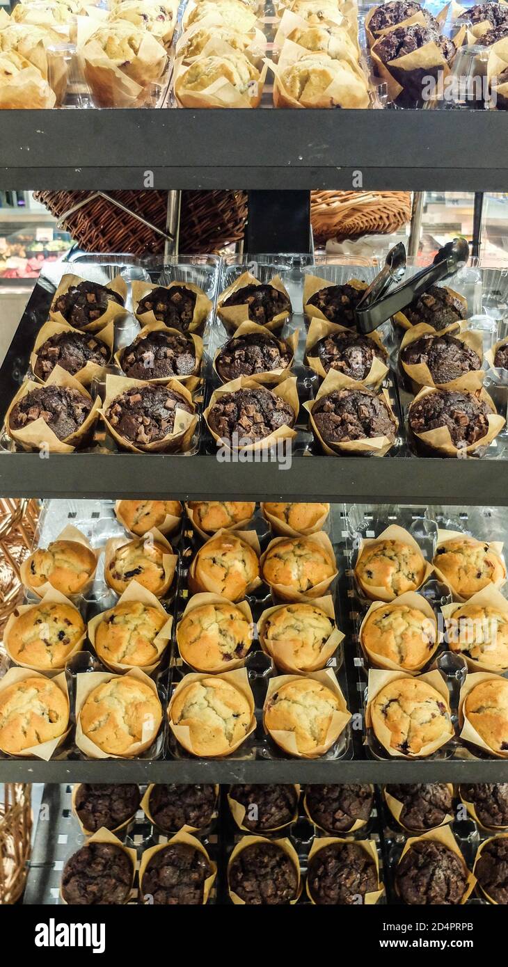 Fresh and tasty muffins on display at the supermarket Stock Photo - Alamy