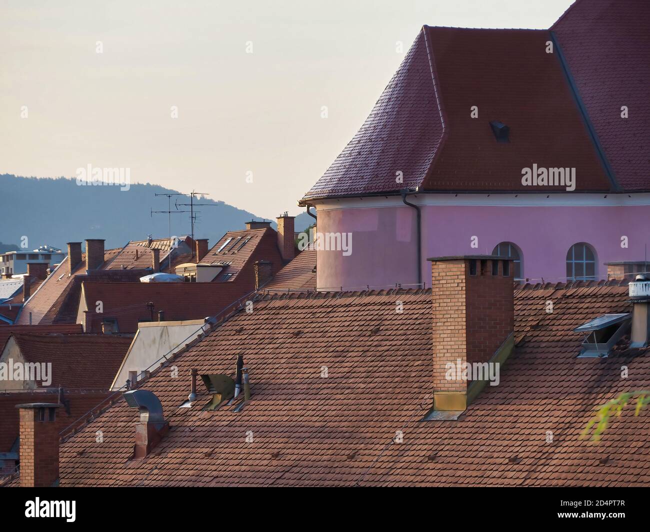 Pink buildings with tiled rooftops Stock Photo - Alamy