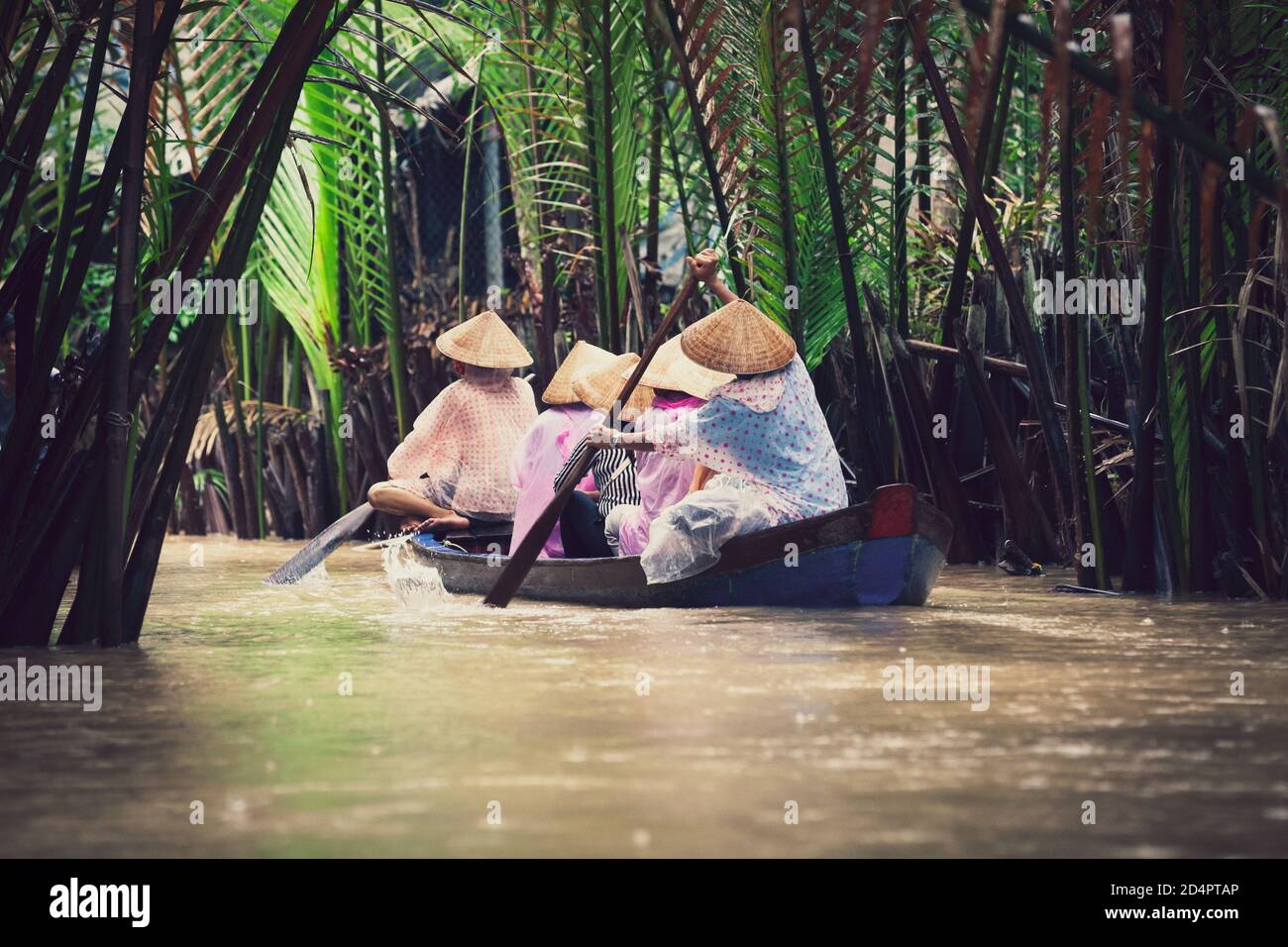 Vietnamese people on a small wooden vessel carrying tourists on the ...