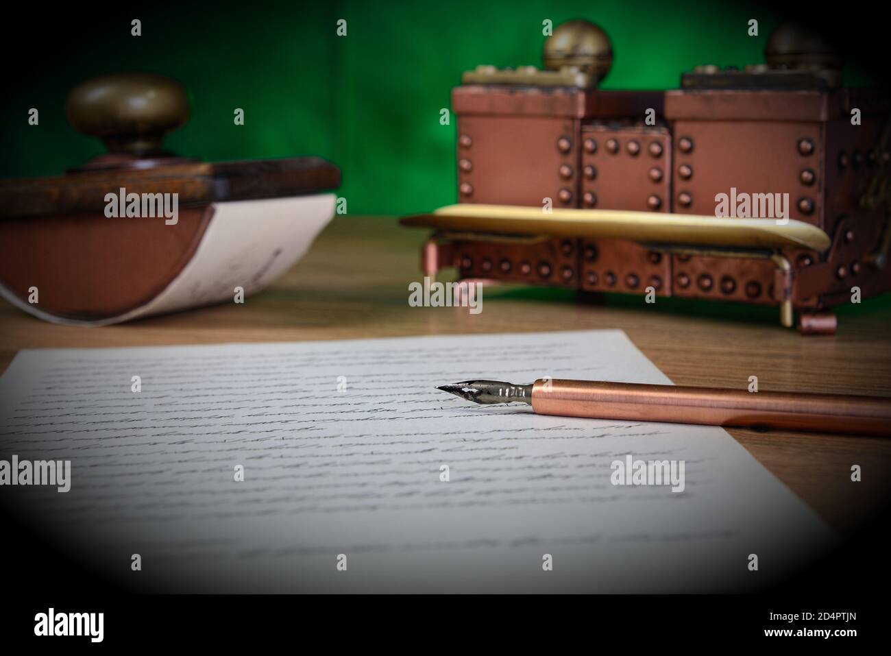 Paper, ink pen, inkstand and paperweight on the table. Low depth of ...