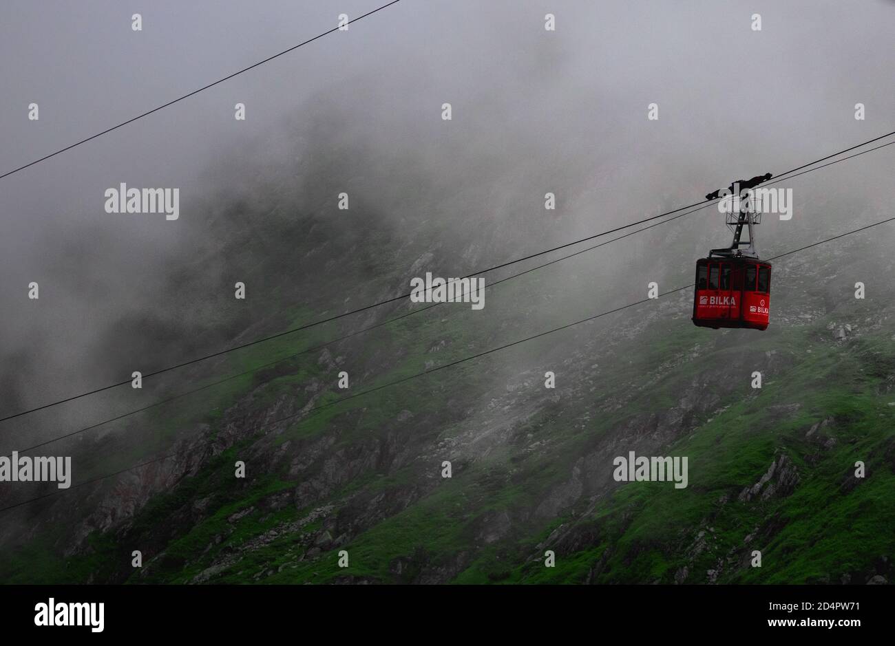 Red Cable Car with green nature, mountain in the background, fog Stock ...