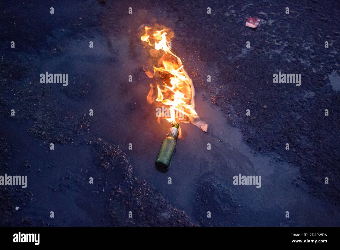 A burning Molotov Cocktail Firebomb seen on the ground during the ...