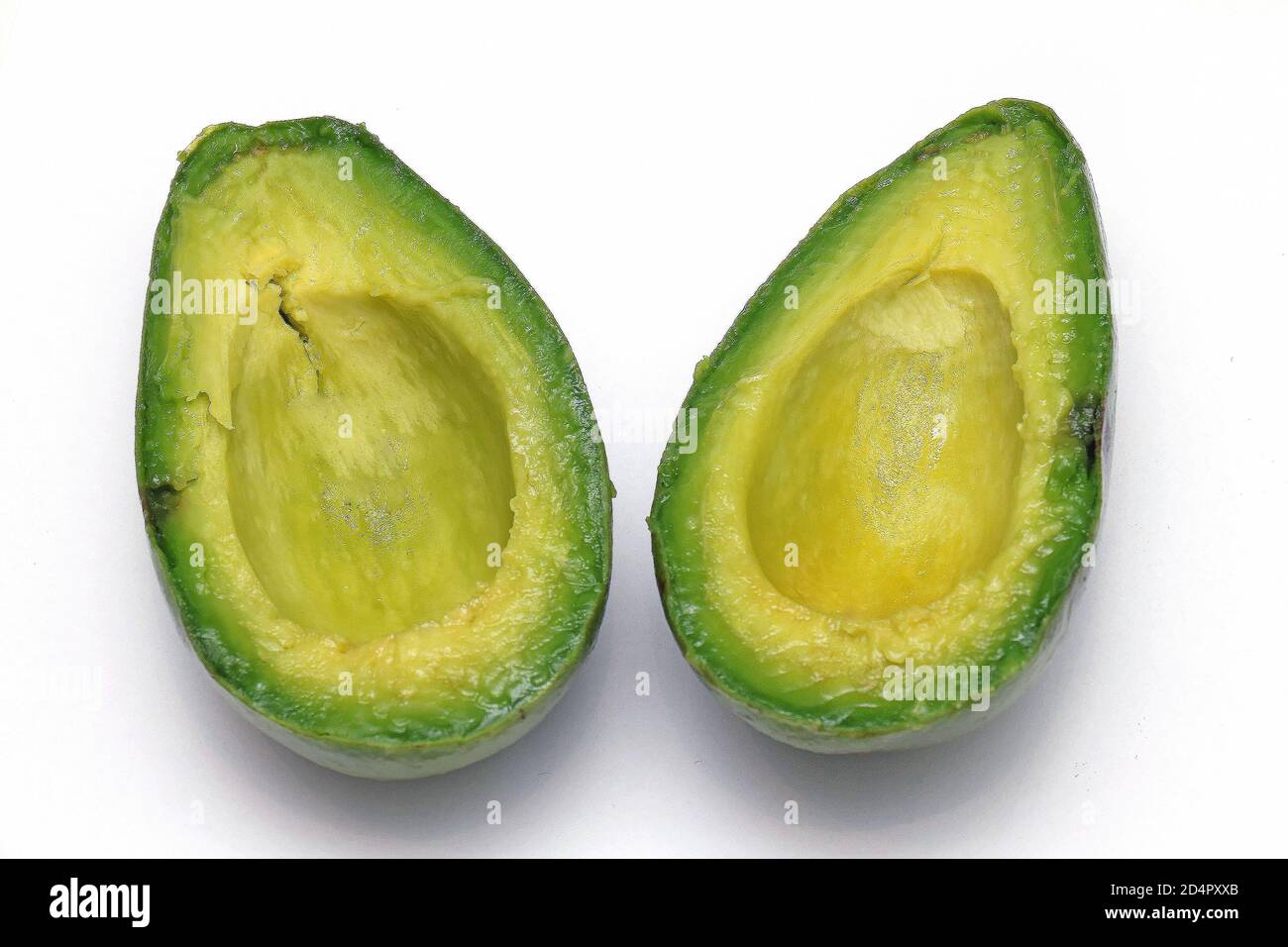 Fresh organic ripe avocado cut in half on white background Stock Photo ...