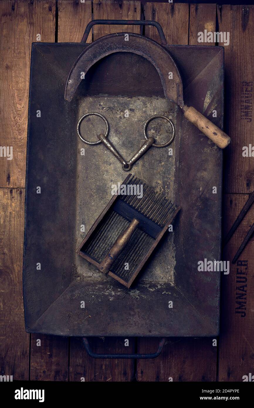 Rural tools, sickle, snaffle, blueberry grater, in an embers tub Stock ...