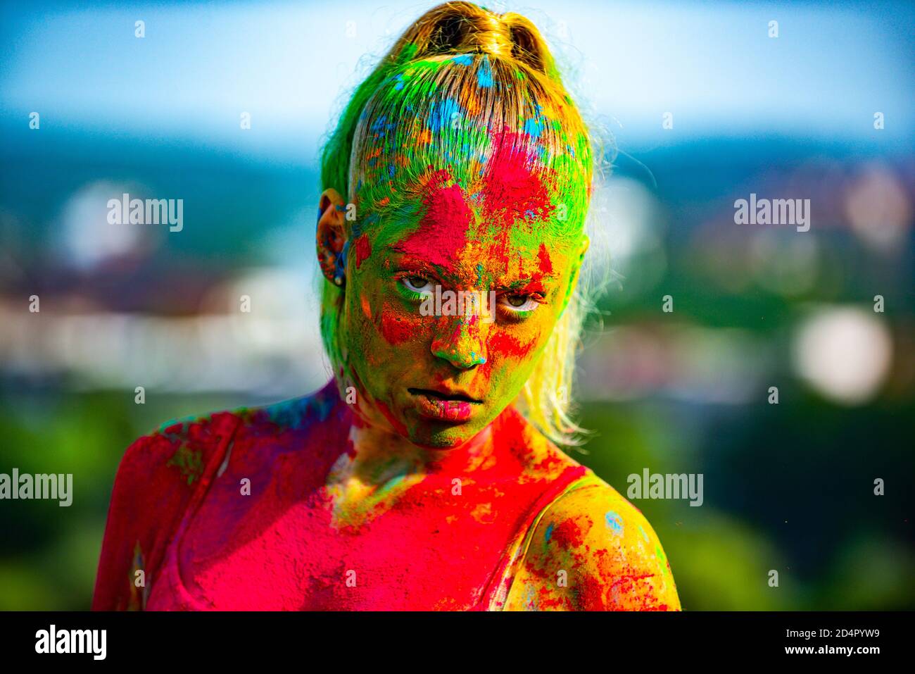 Color face with colorful holi splash. Close-up portrait of a young ...
