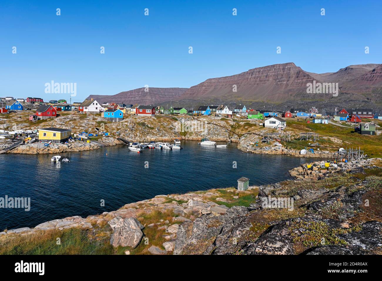 Village view with typical colourful painted houses, in front bay with ...