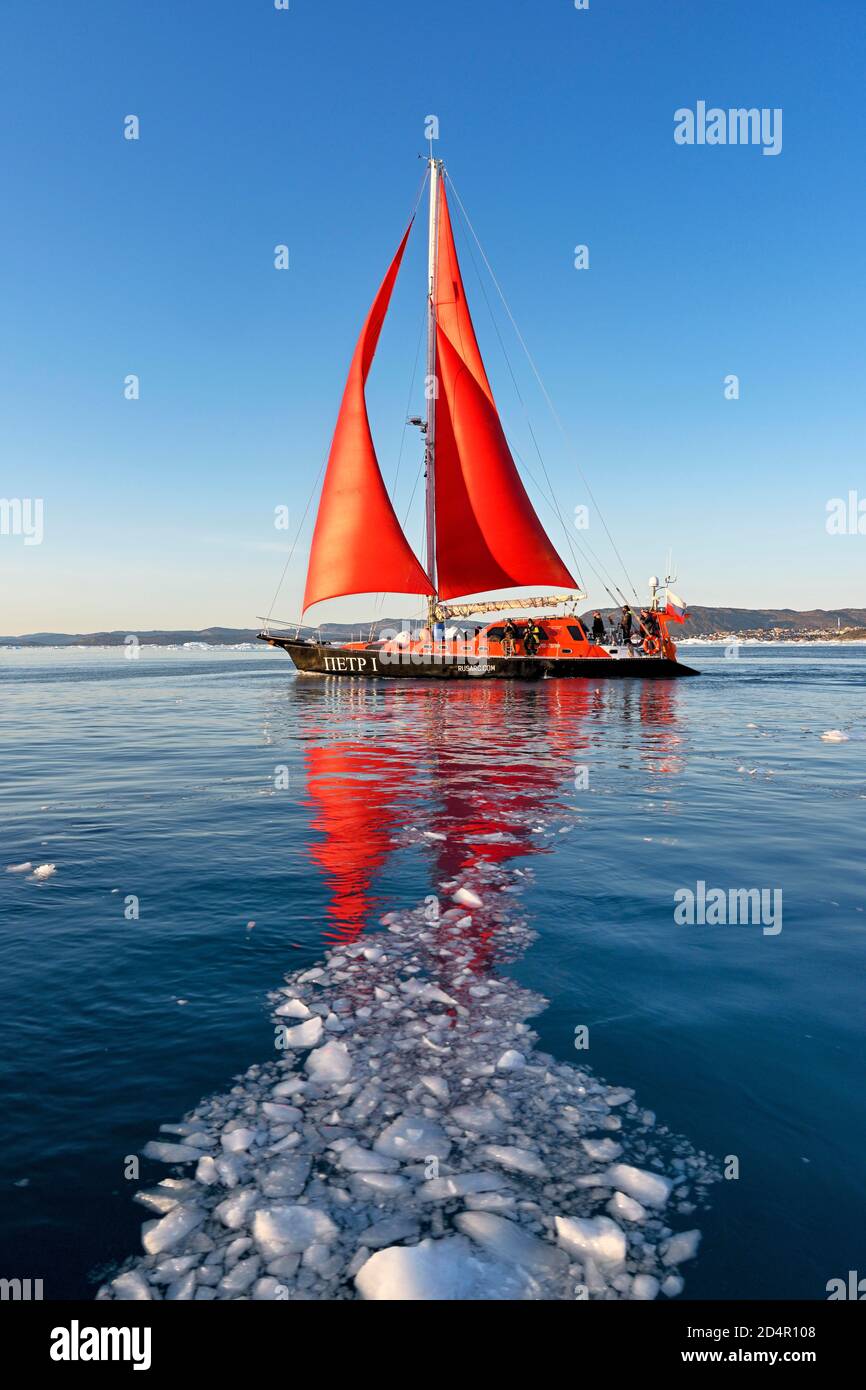Red sailing boat in drift ice, Icefjord, UNESCO World Heritage Site ...