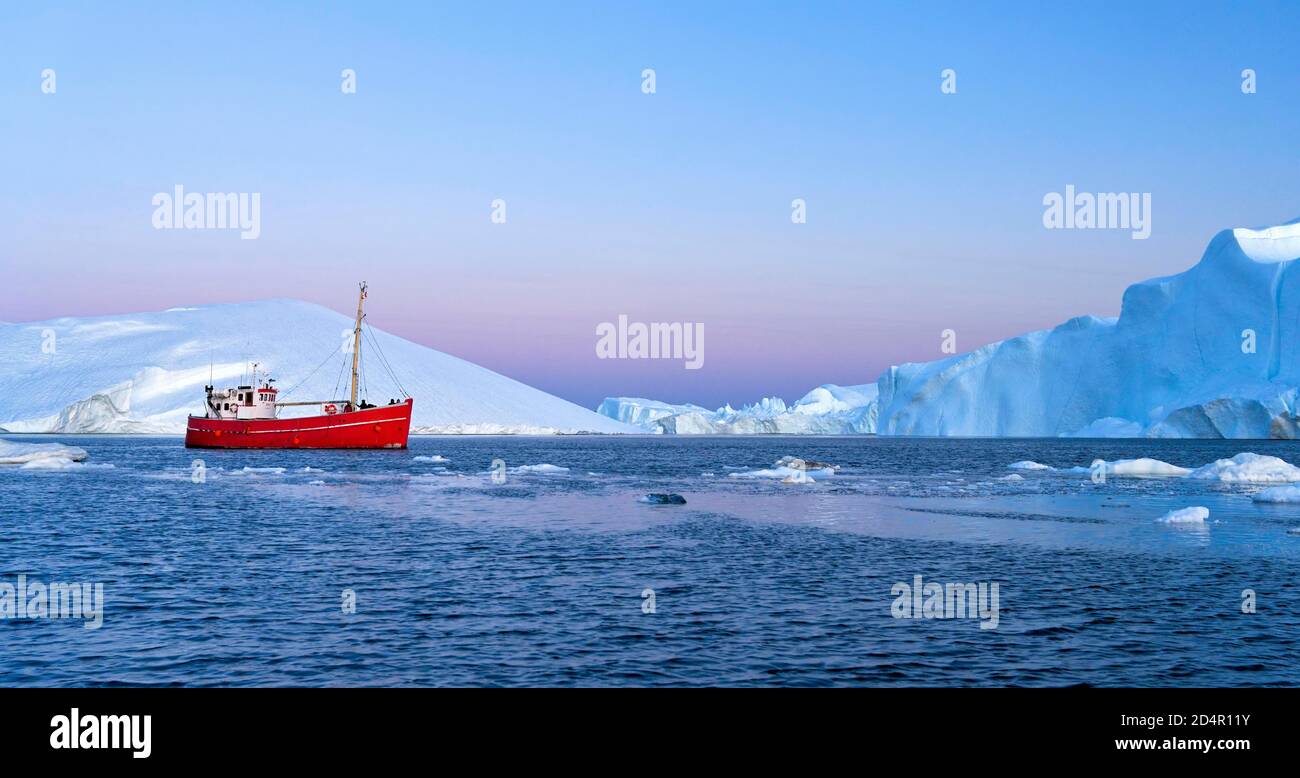 Red boat in front of icebergs at the blue hour, Icefjord, UNESCO World ...