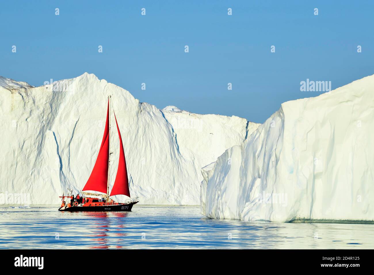 Red sailing boat in front of gigantic icebergs, Icefjord, UNESCO World ...