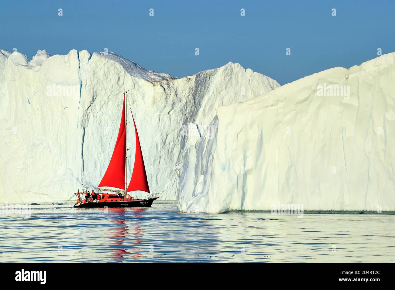 Red sailing boat in front of gigantic icebergs, Icefjord, UNESCO World ...