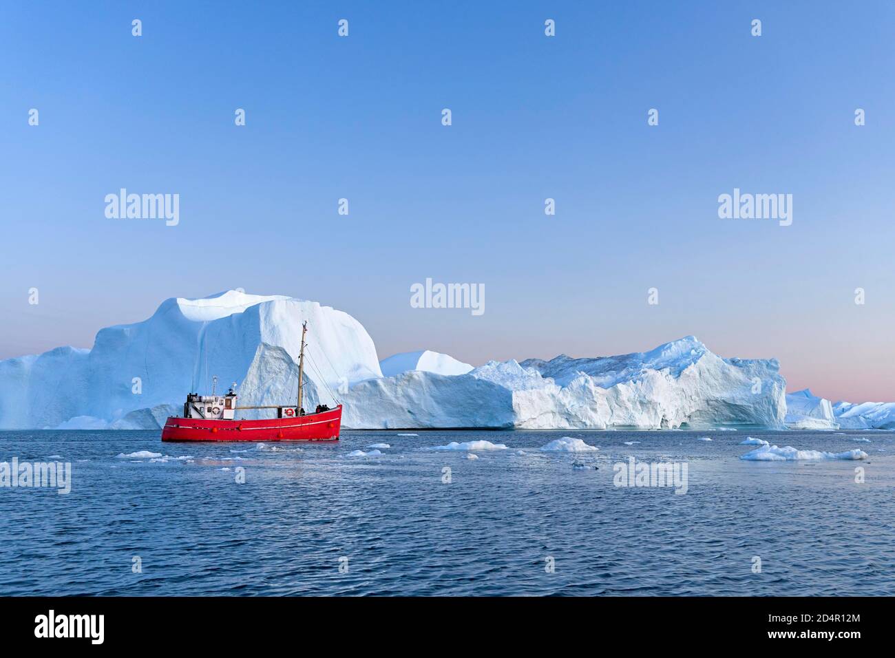 Red boat in front of icebergs at the blue hour, Icefjord, UNESCO World ...