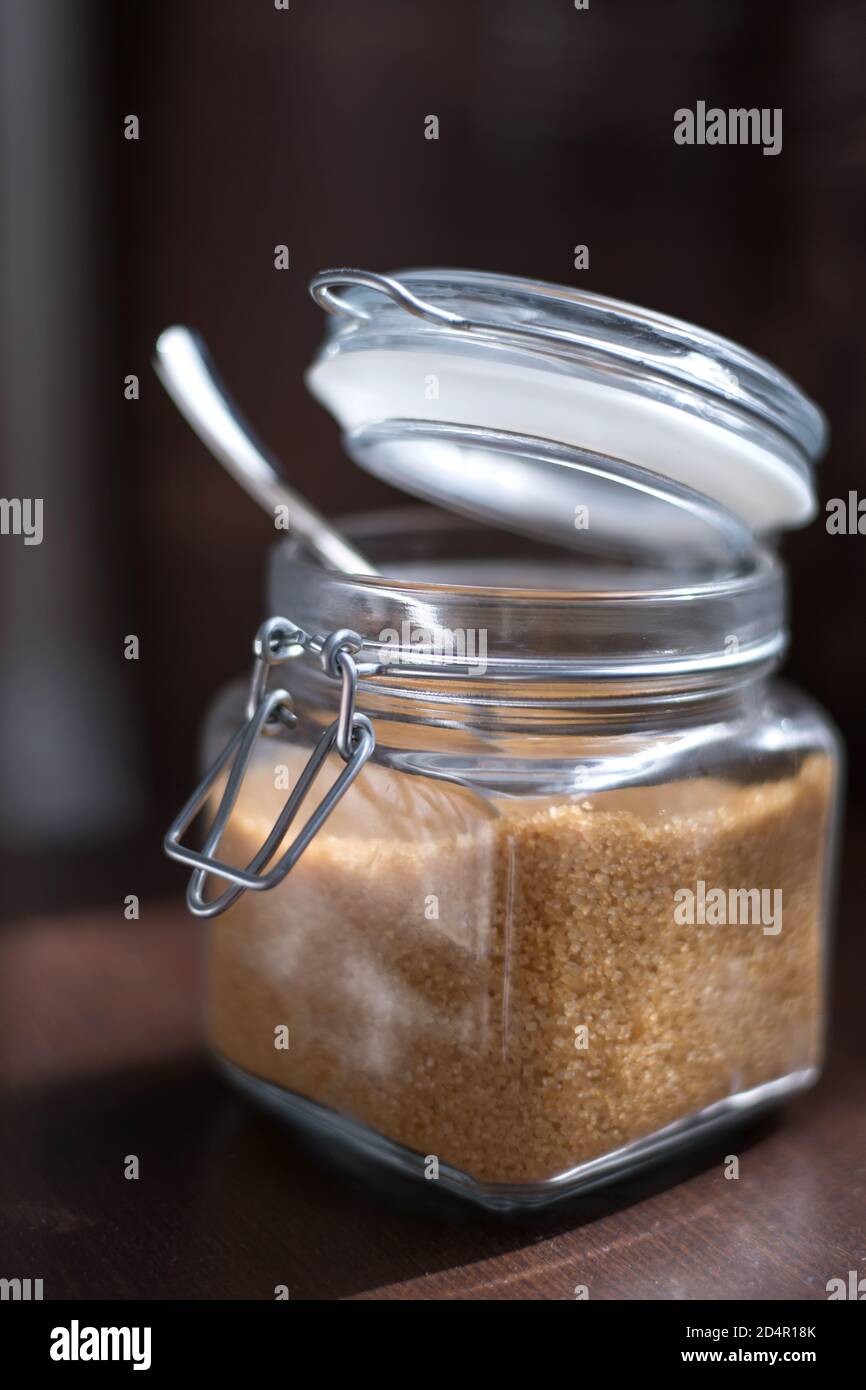 Transparent glass jar with brown sugar cane on a black background Stock ...